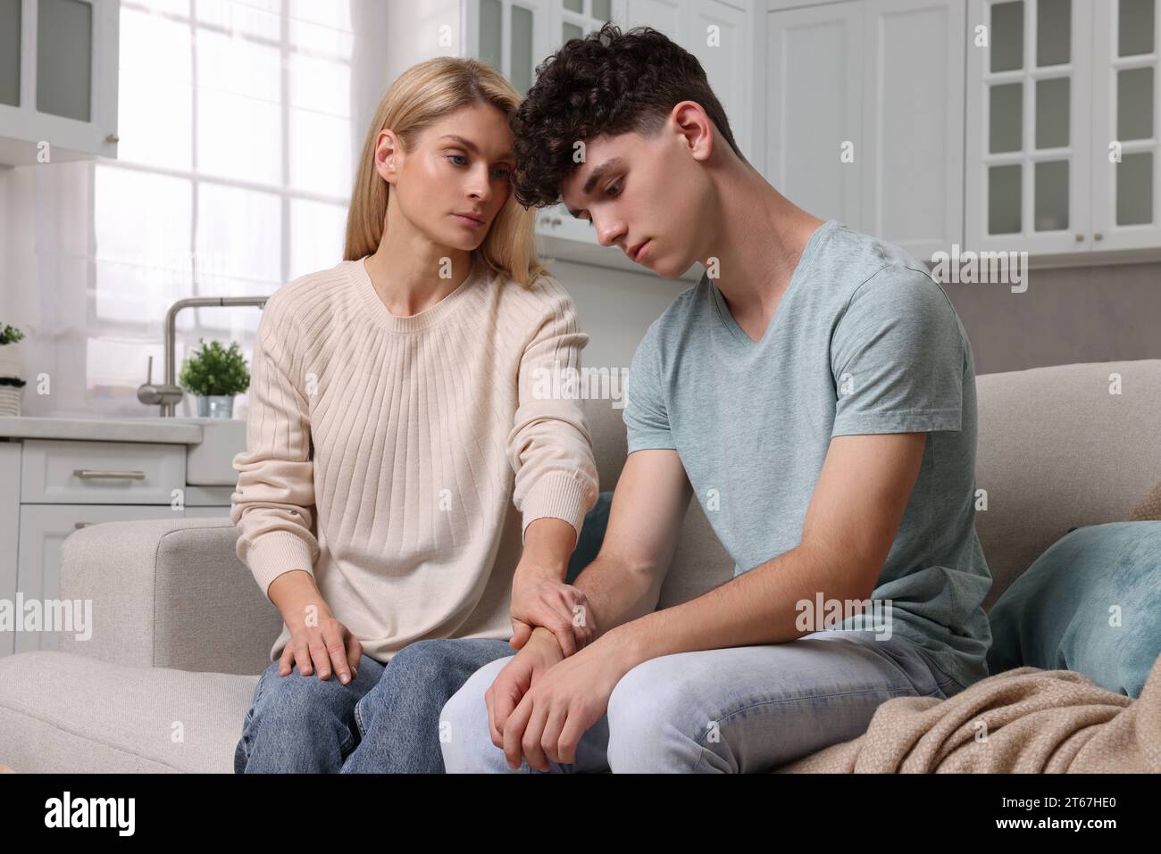 Mother consoling her upset son at home. Teenager problems Stock Photo ...