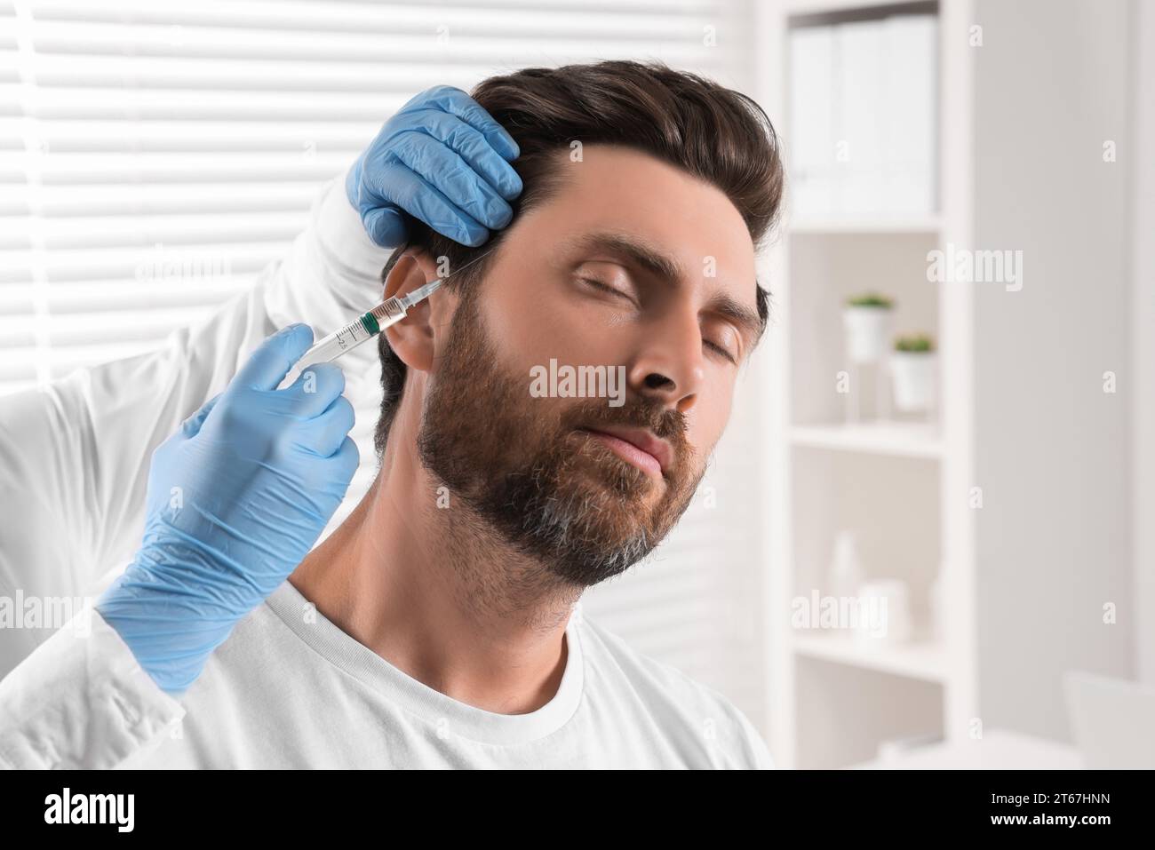 Trichologist giving injection to patient in clinic, closeup Stock Photo ...
