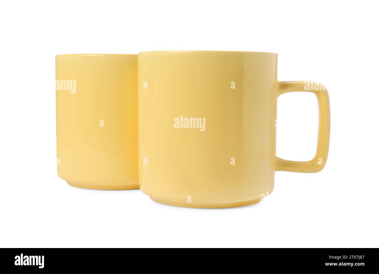 Two yellow ceramic mugs isolated on white Stock Photo - Alamy