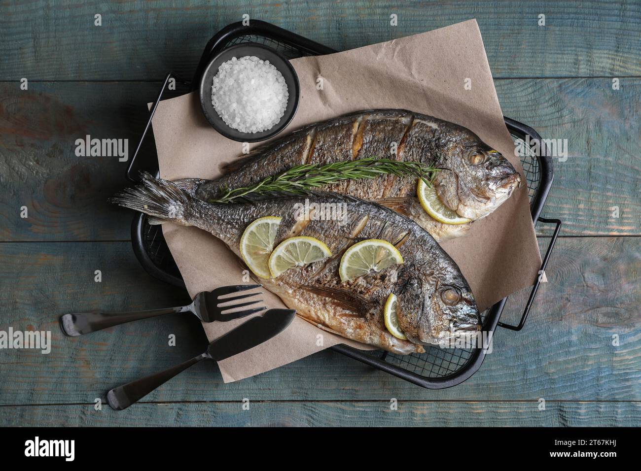 Delicious baked fish served on wooden rustic table, top view. Seafood ...