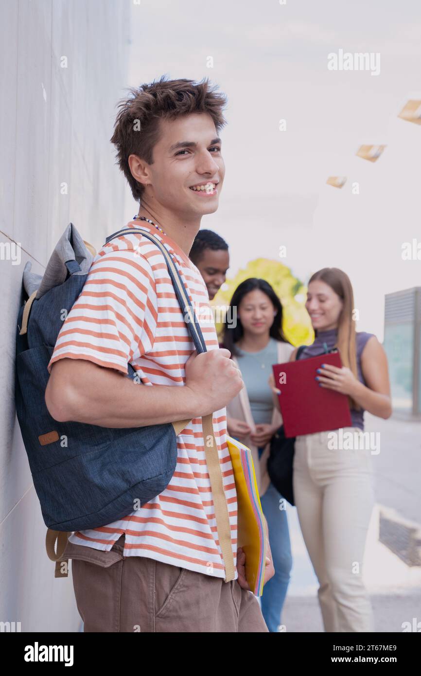 Vertical shot Happy student on campus smiling at the camera outdoors ...