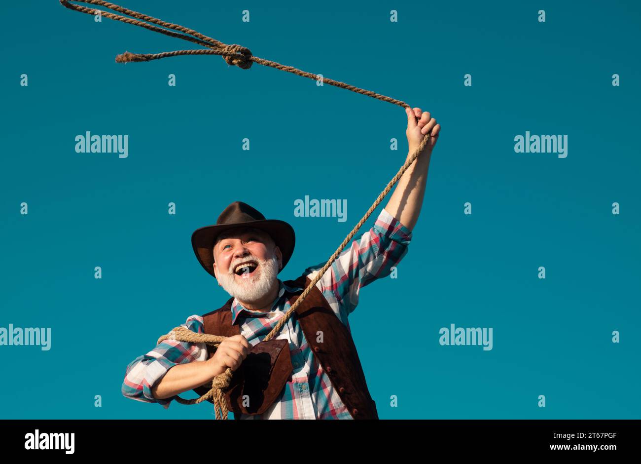 Old wild west cowboy with lasso rope. Bearded western man with brown ...
