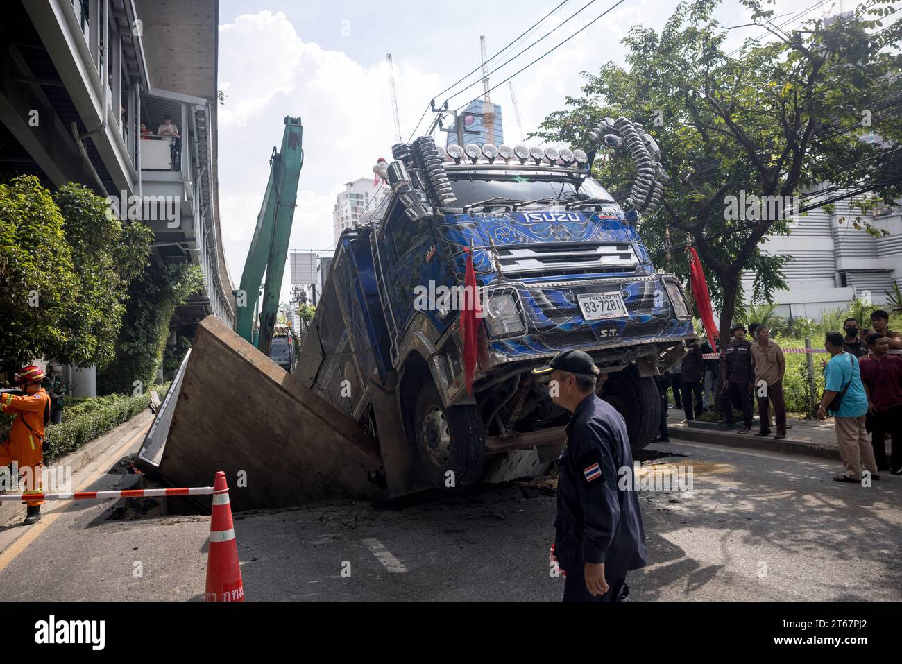 A truck sits in a section of collapsed road after the ground gave way ...