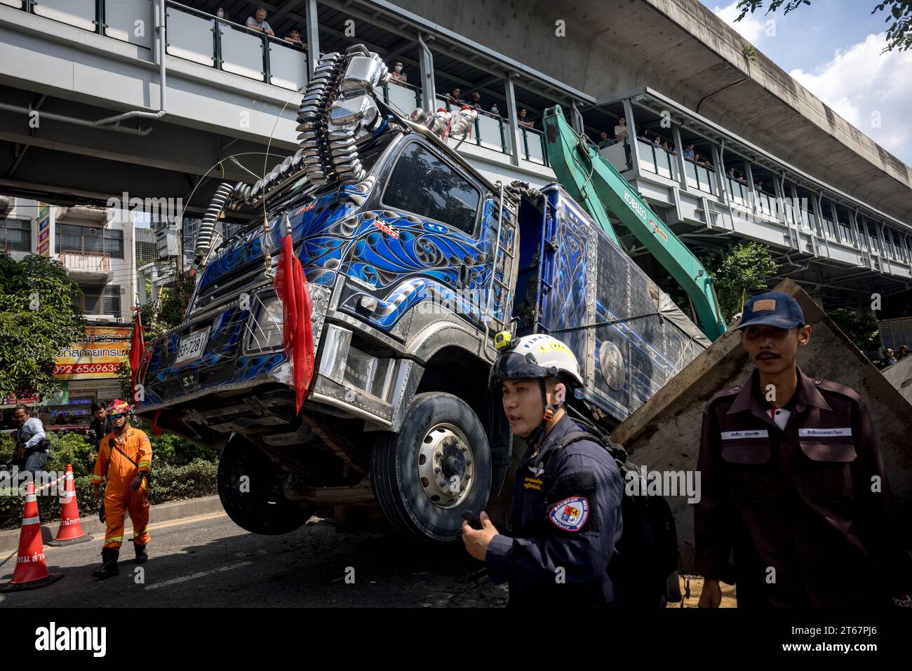A truck sits in a section of collapsed road after the ground gave way ...
