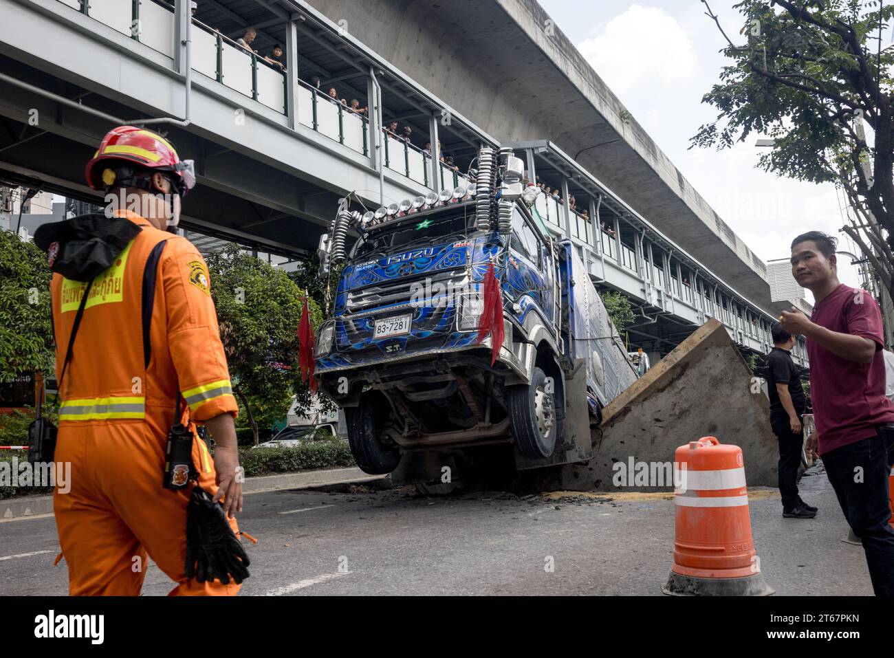 A truck sits in a section of collapsed road after the ground gave way ...