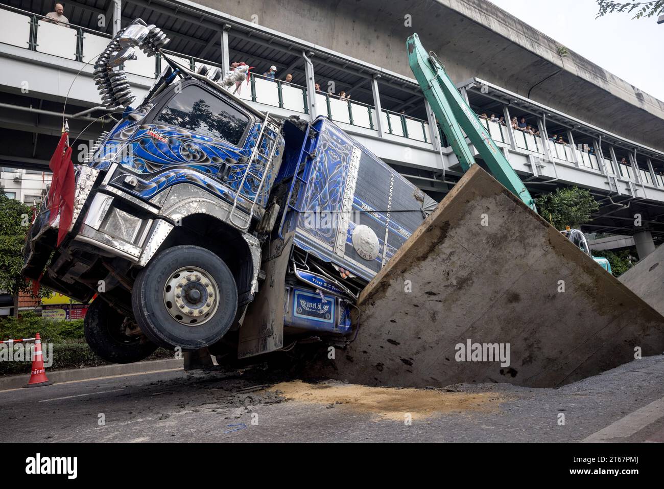 A truck sits in a section of collapsed road after the ground gave way ...