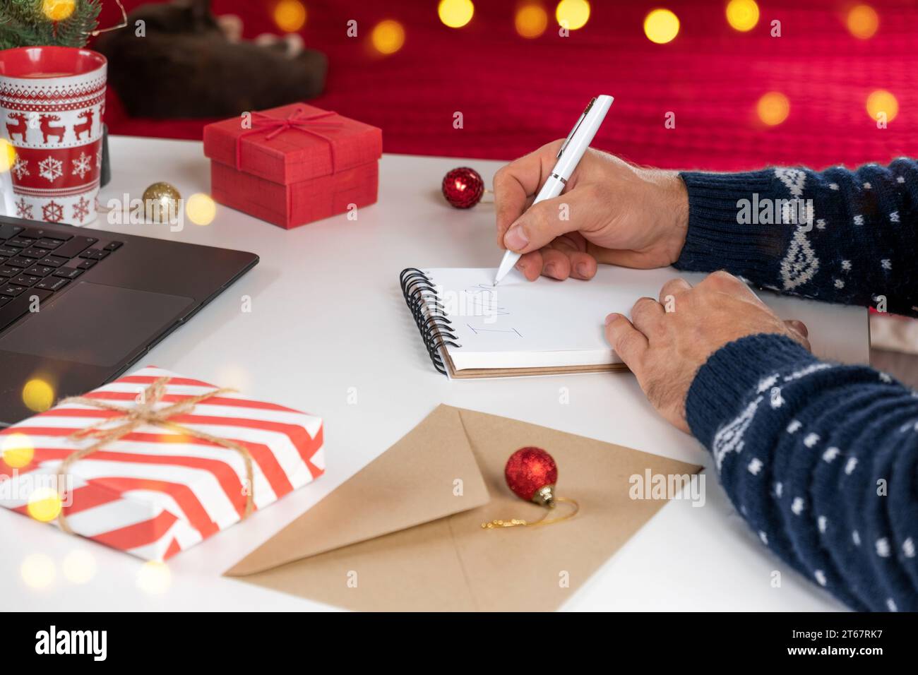 Writing a Christmas Wishing Card. Male adult making greeting cards at ...
