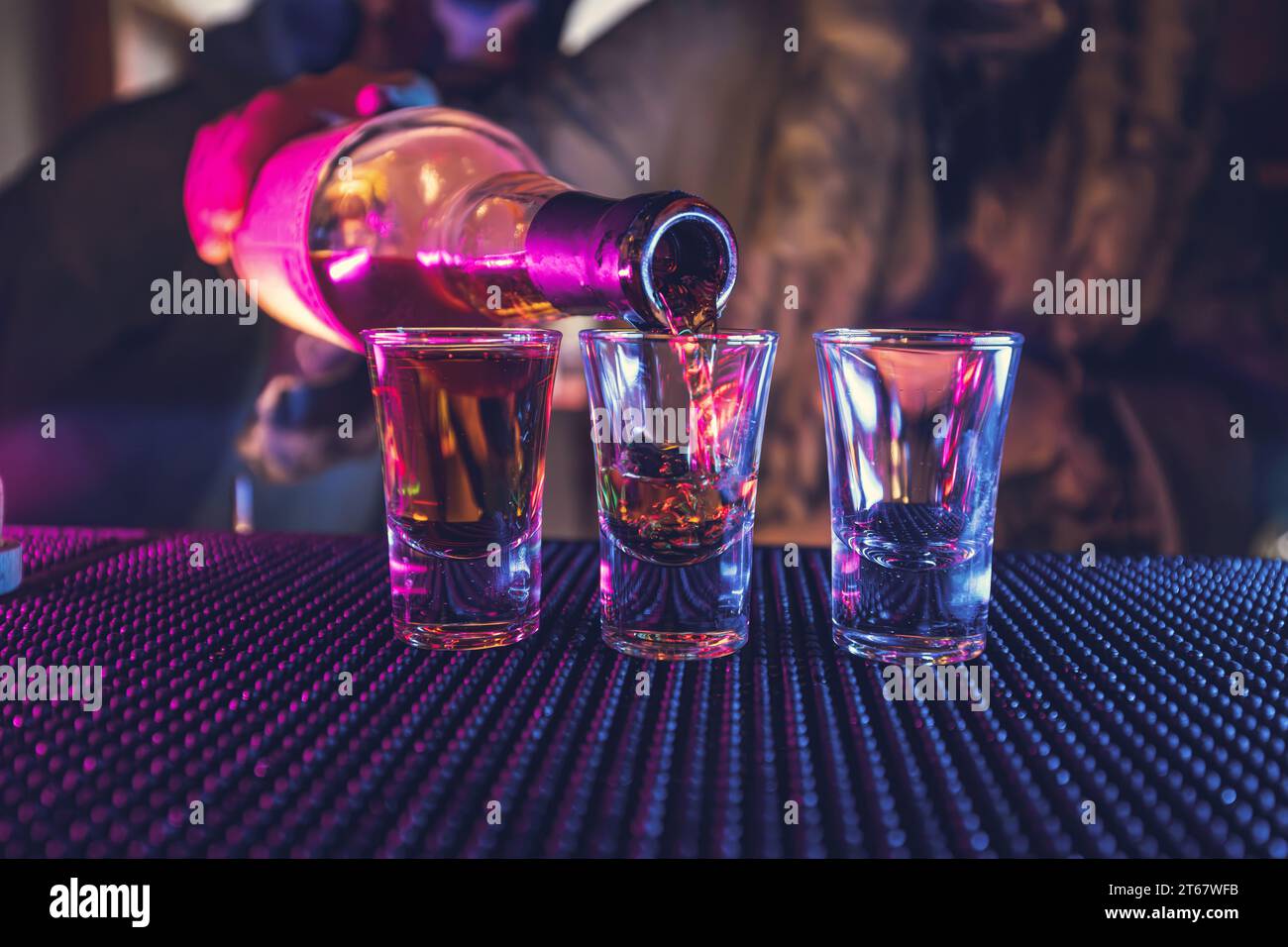 Bartender pouring and serving alcoholic drinks at bar Stock Photo - Alamy