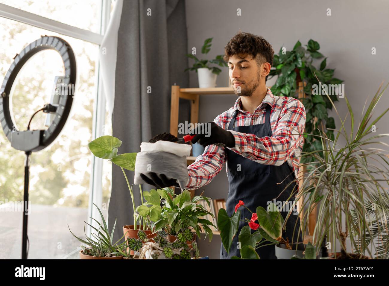 Arabic male gardener influencer films video for blog gives ...