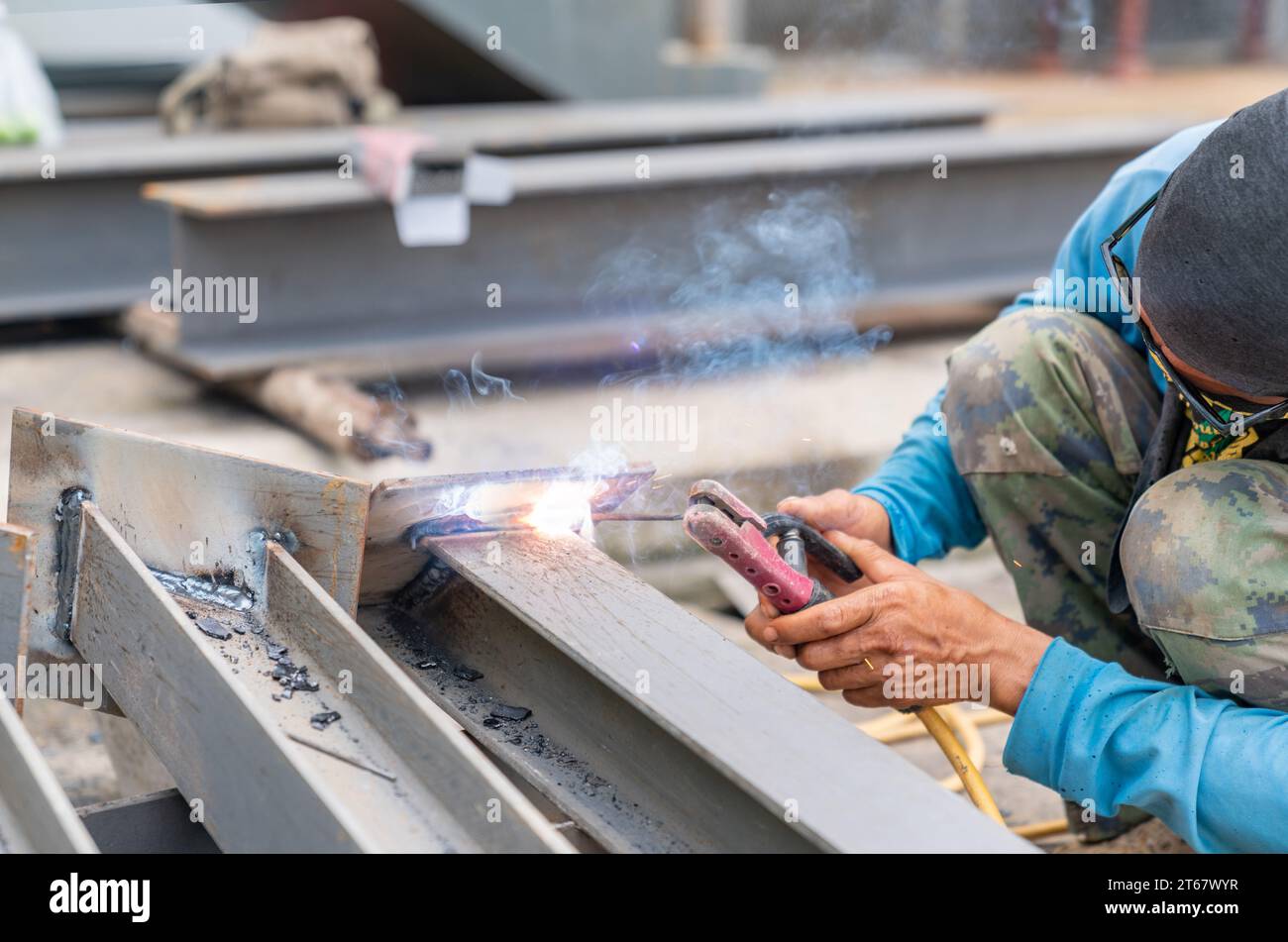Worker welding plate of iron beam for suport structure in construction ...