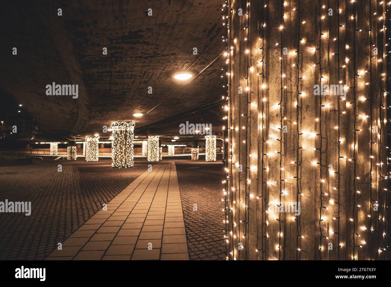 lighting on pillars under a bridge Stock Photo - Alamy