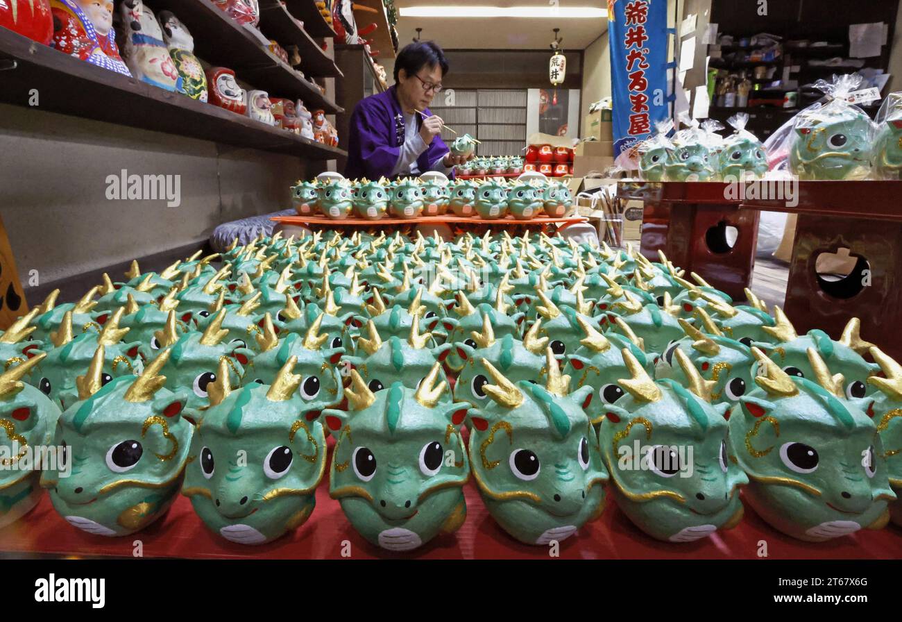 A craftsman makes a potbellied dragon at his workshop in Hiratsuka ...