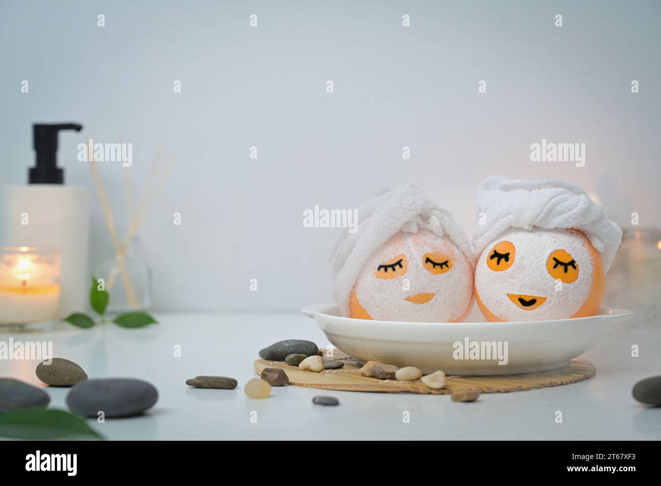 Two orange fruits in face mask looking like in bath or Onsen. Spa ...