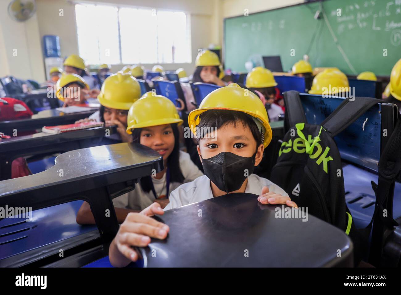 Quezon City, Philippines. 9th Nov, 2023. Students wearing hard hats ...