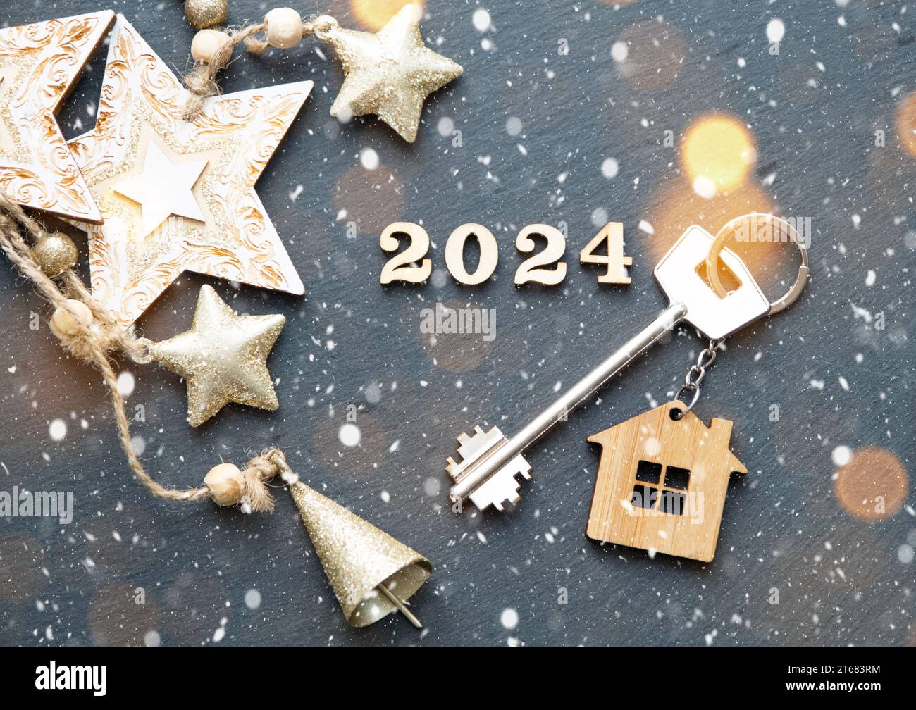 House key with keychain cottage on festive background with stars ...