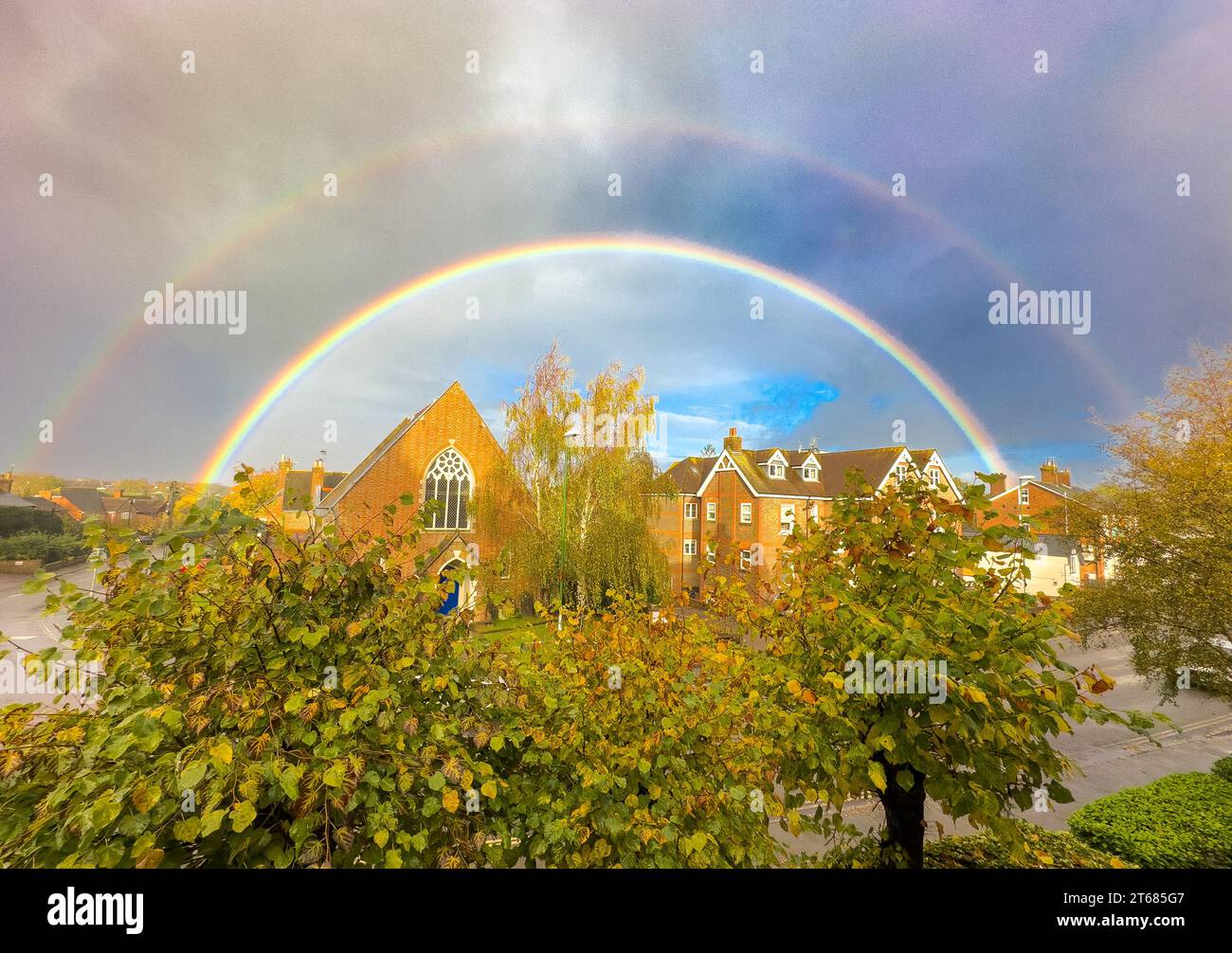 Billingshurst / UK - Nov 9 2023: A double rainbow arches over a church ...
