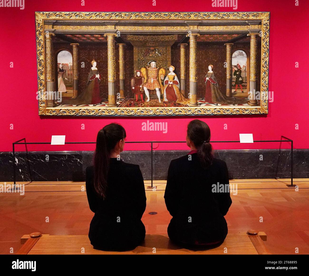 Members of Royal Collection Trust staff observe a portrait of the ...