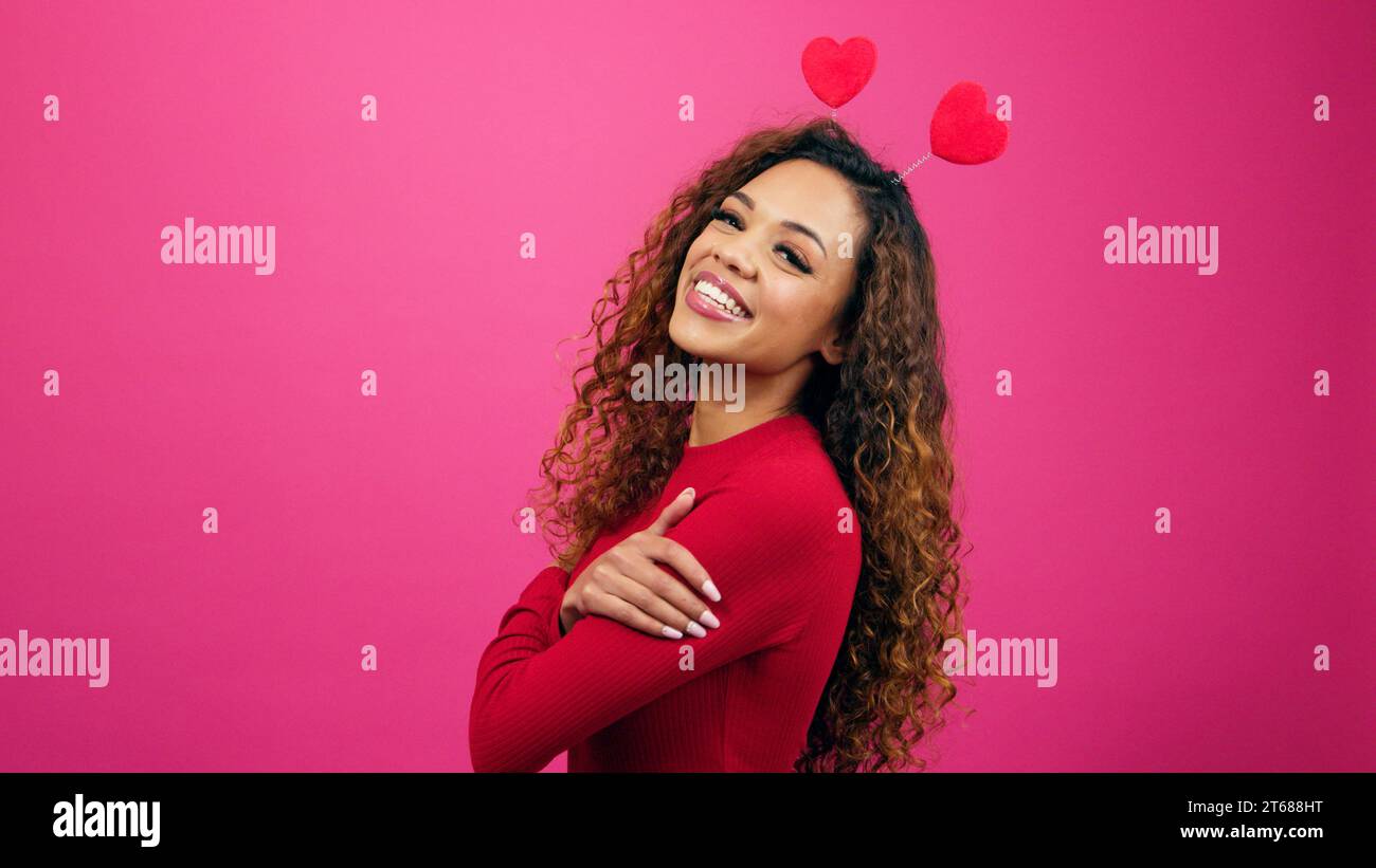 Beautiful young woman embraces herself, self love, love yourself ...