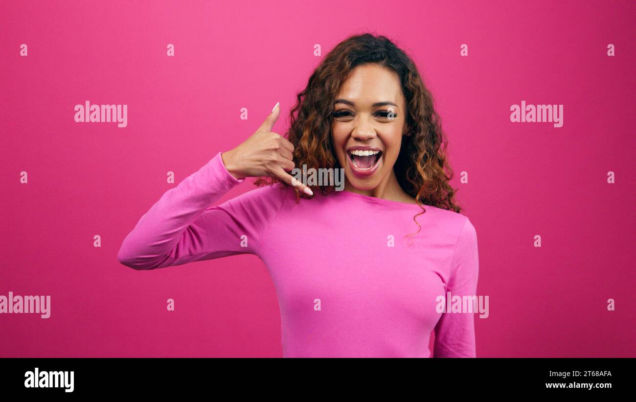 Flirty young woman makes Call Me sign, secret admirer Valentine's Day ...