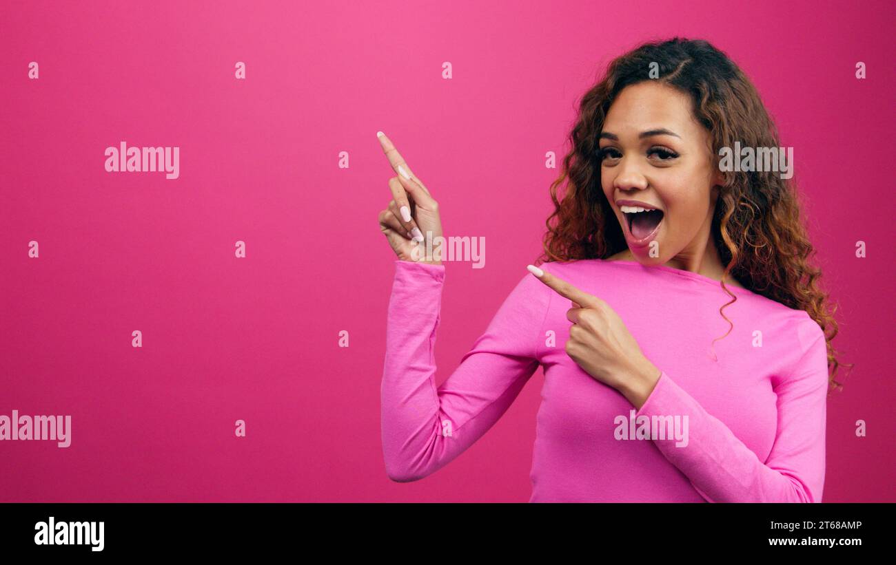 Woman points fingers smiling hi-res stock photography and images - Alamy
