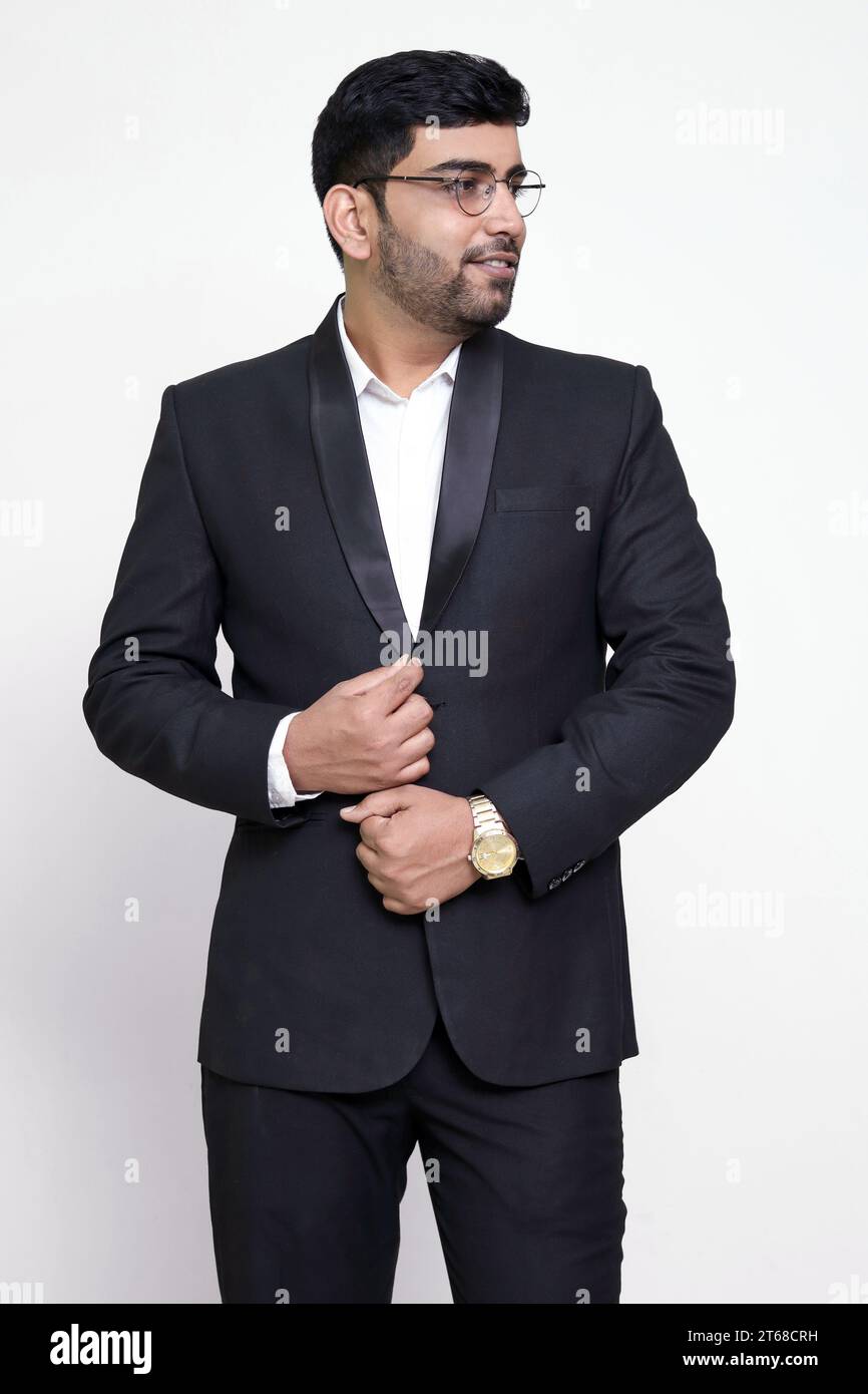 A portrait of a young Indian male wearing a suit with a white ...