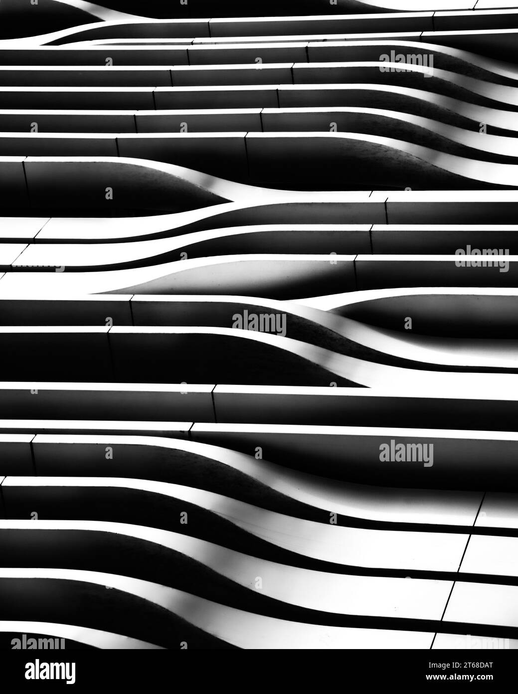 A high-contrast black and white image of a textured brick wall with ...