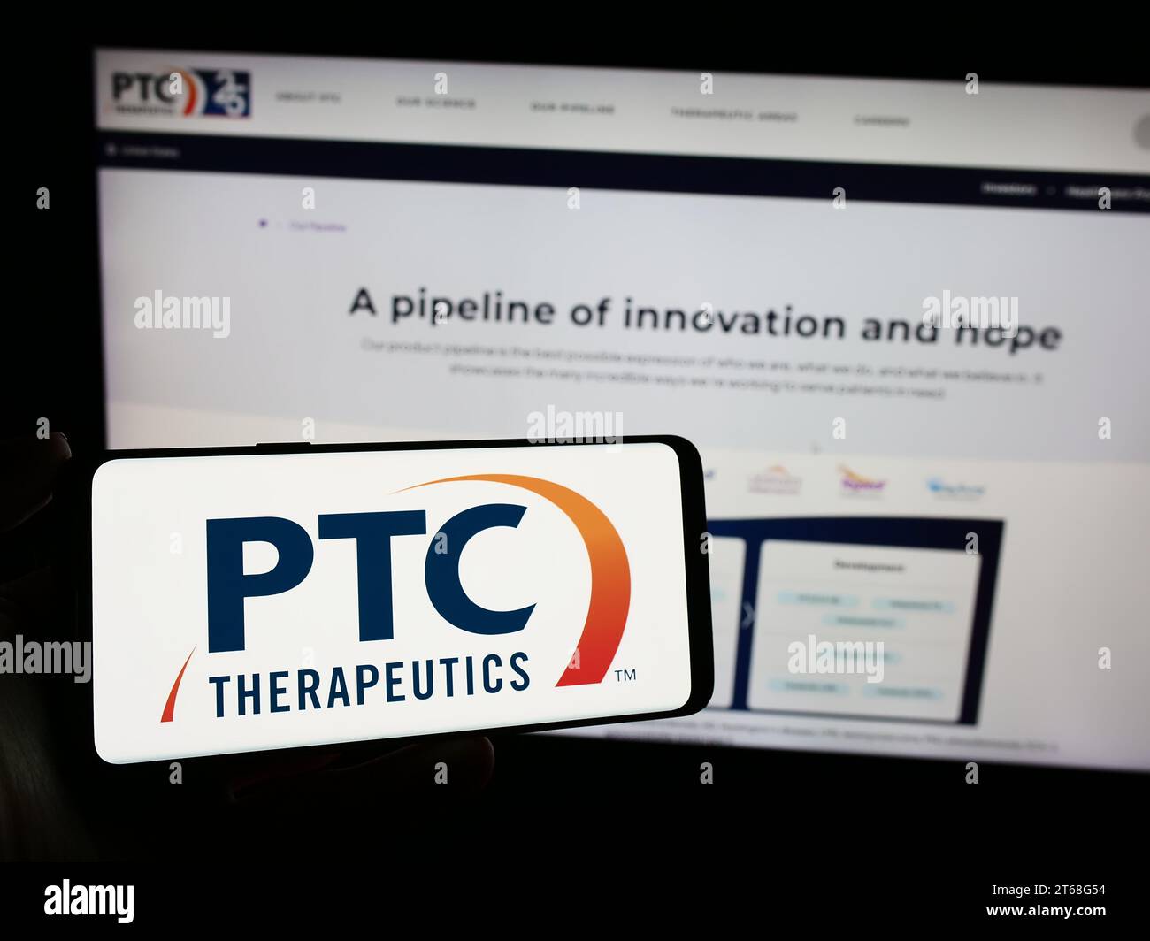 Person holding smartphone with logo of US pharmaceutical company PTC ...