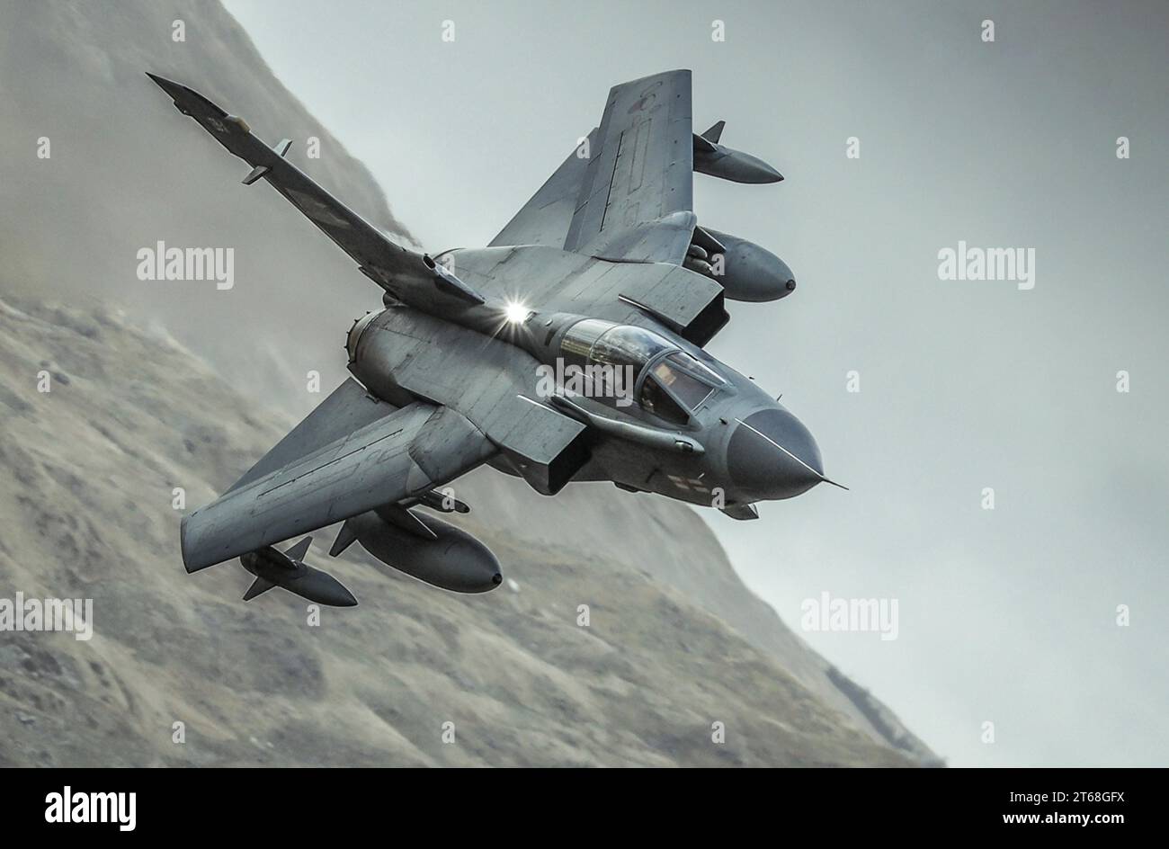An aerial view of a commercial aircraft coming into land on a mountain ...