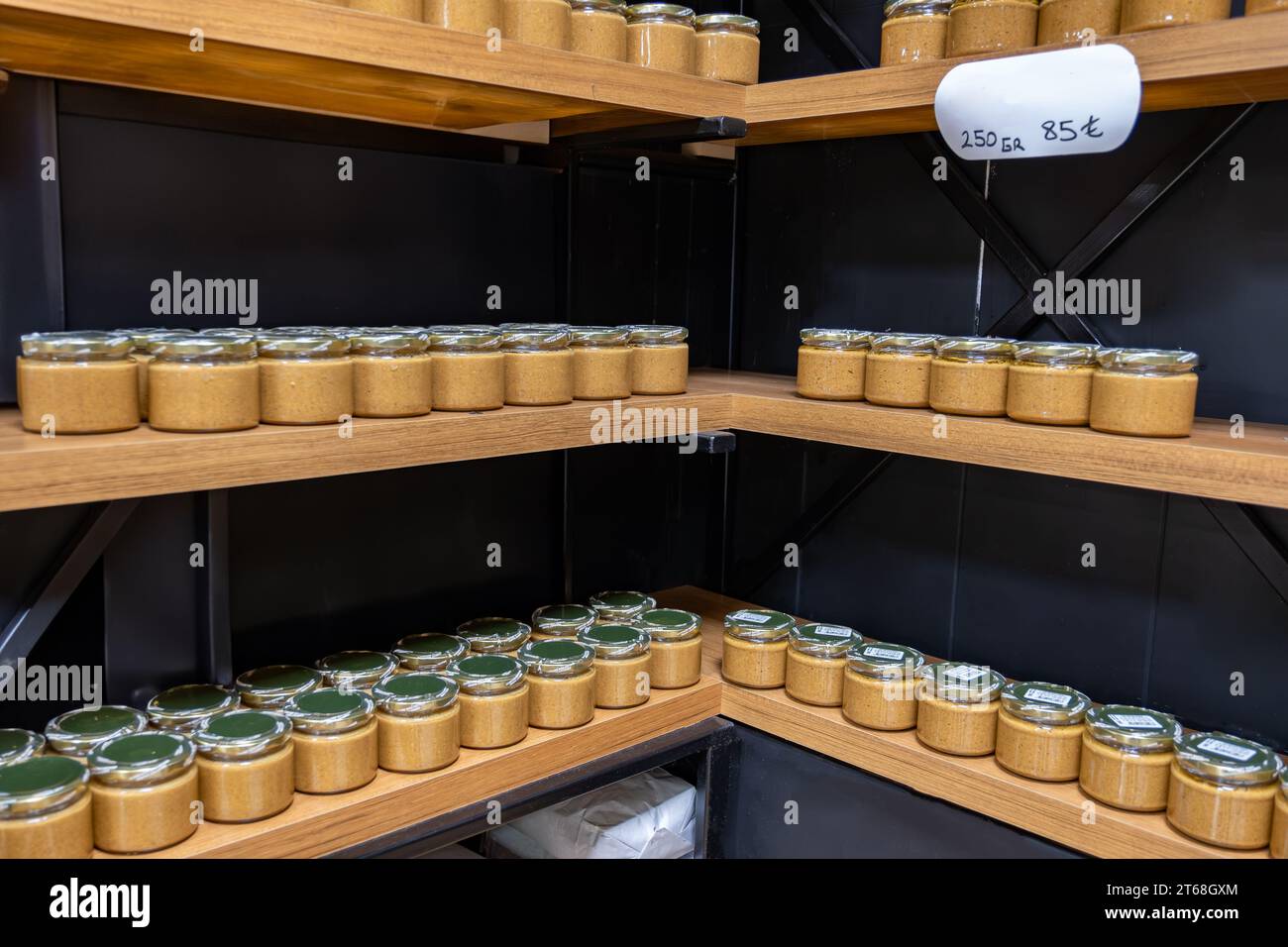 jars of cream on store shelf with price tag under the jar on black ...