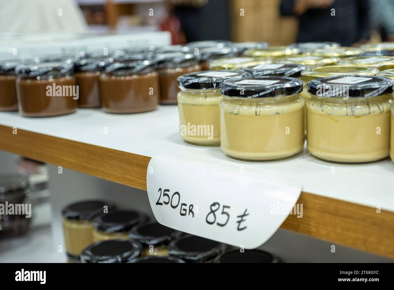jars of cream on store shelf with price tag under the jar on black ...