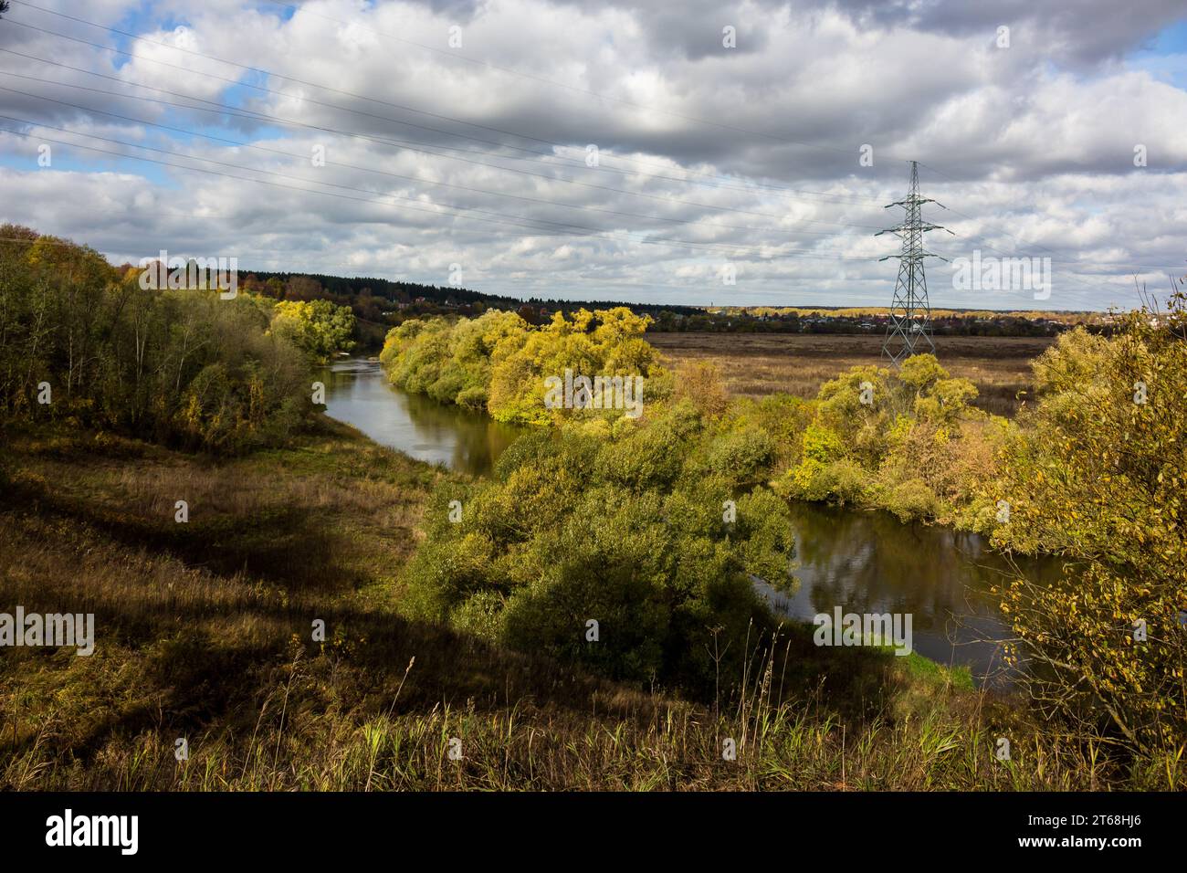 Scenic view of a river valley with a power line crossing the river ...