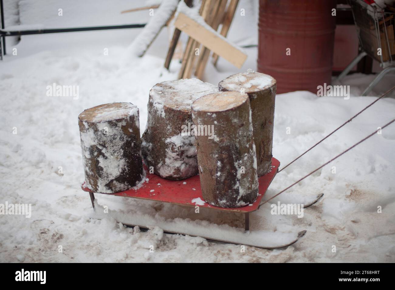 Logs on a sleigh. Logs for splitting with an axe. Transportation of dry ...