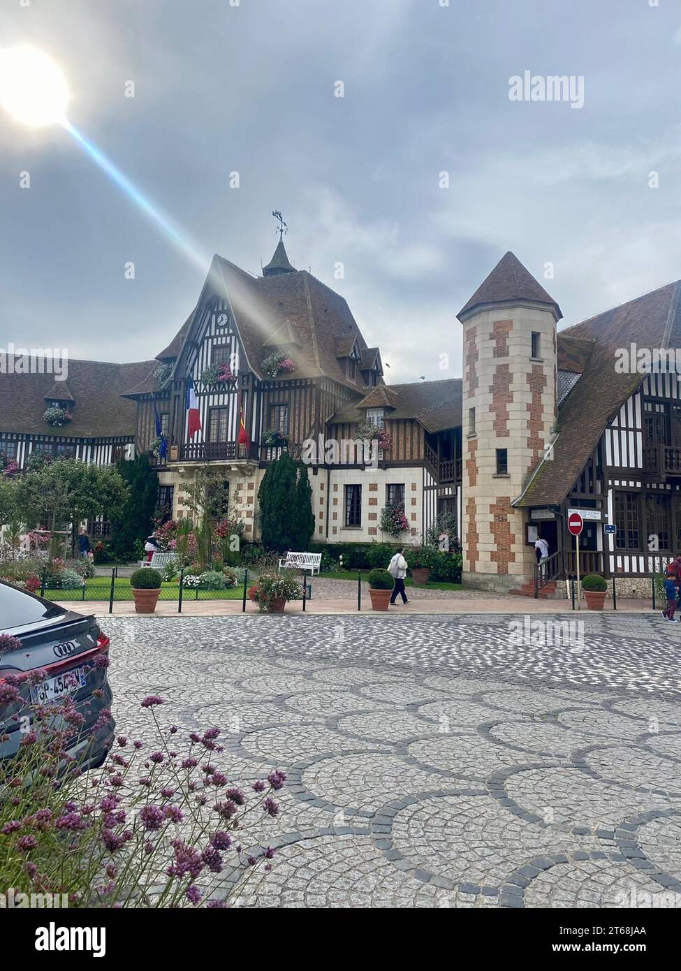 A majestic building with a stately tower in the center, set in front of ...