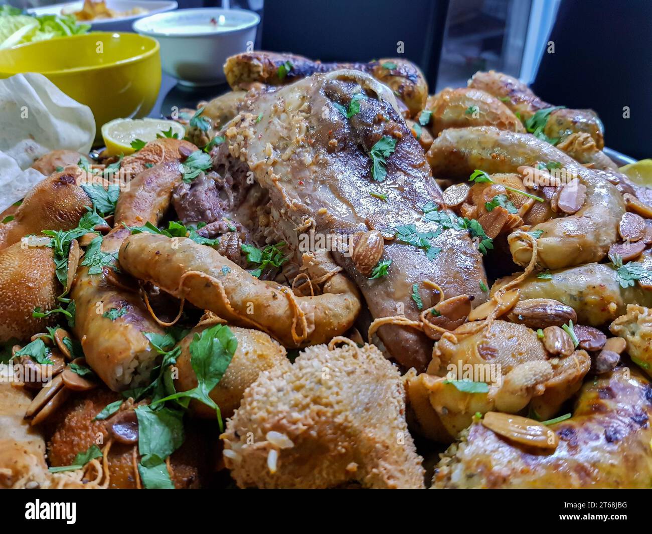 Top view of Tripes, empties, and legs with lemon and herbs on black ...