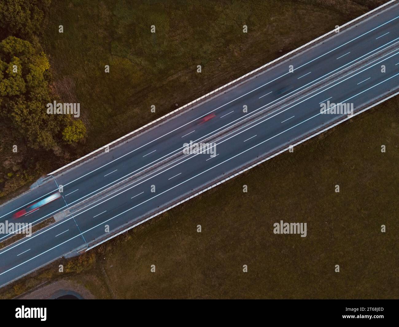 Aerial view of a highway with two lanes of traffic, one lane of ...
