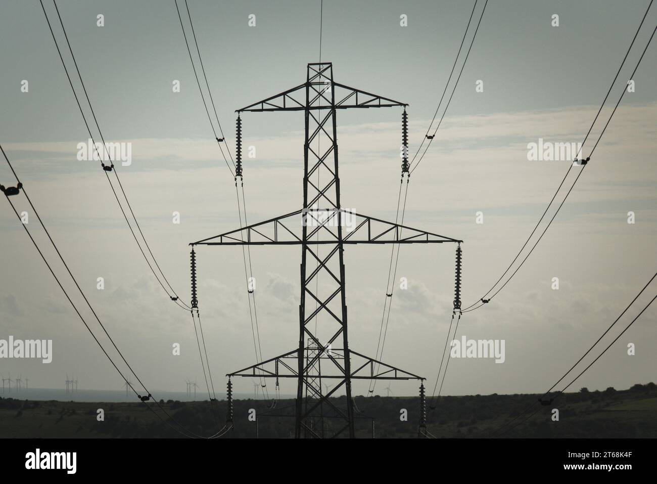 An aerial view of a series of high voltage electrical towers and power ...