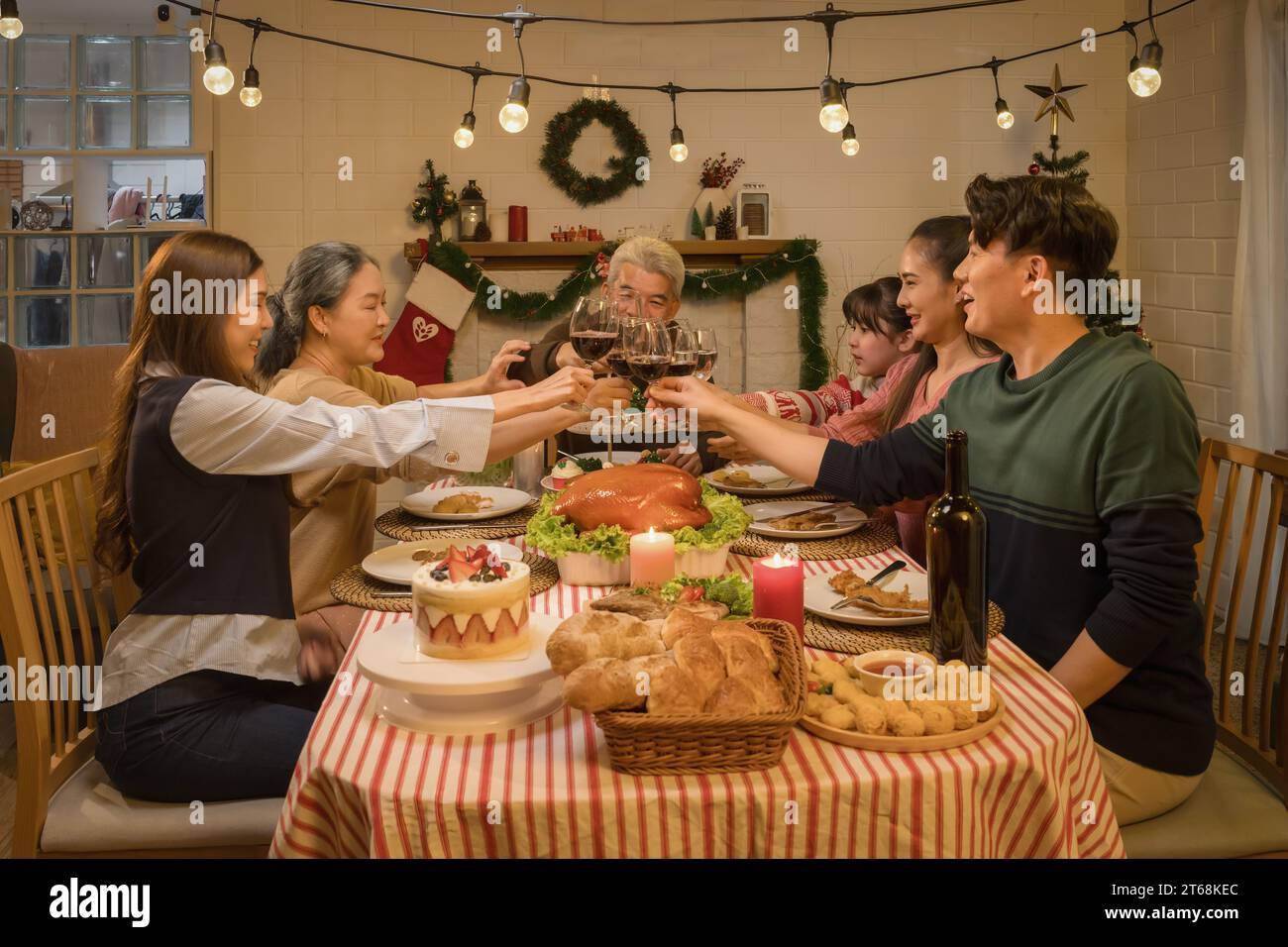 Asian family capturing unforgettable moments around a bountiful table ...