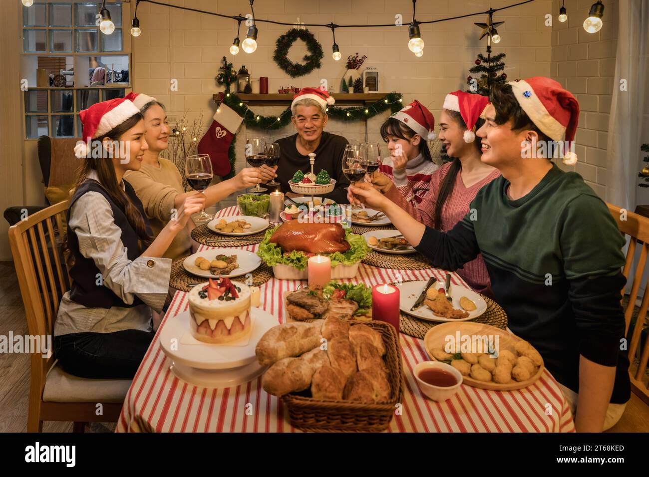 Asian family gathering around the table celebrating Thanksgiving and ...