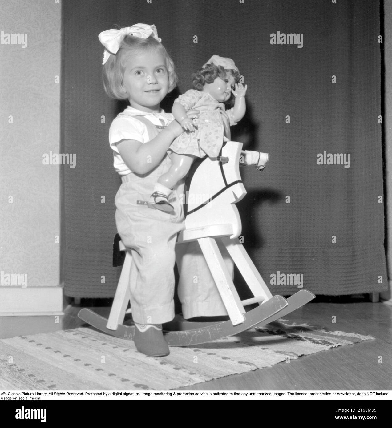 Girl in the 1950s. She must be a happy child, sitting on a rocking ...