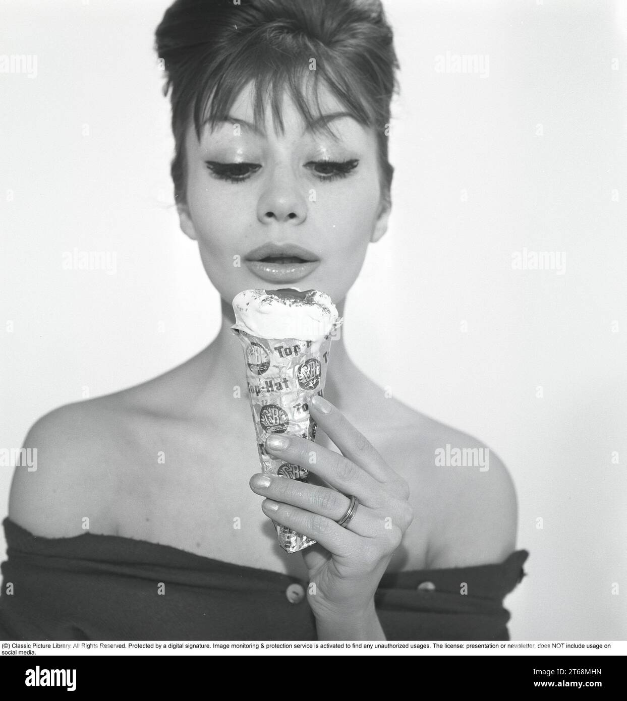 Ice cream in the 1960s. A young woman enjoys a ice cream. Sweden 1965 ...