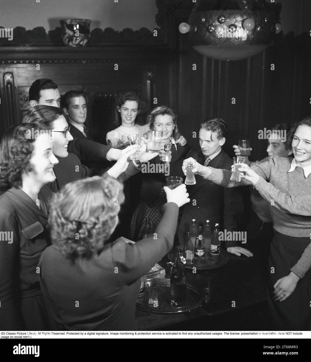 In the 1940s. A non-alcohol toast with young people raising their ...