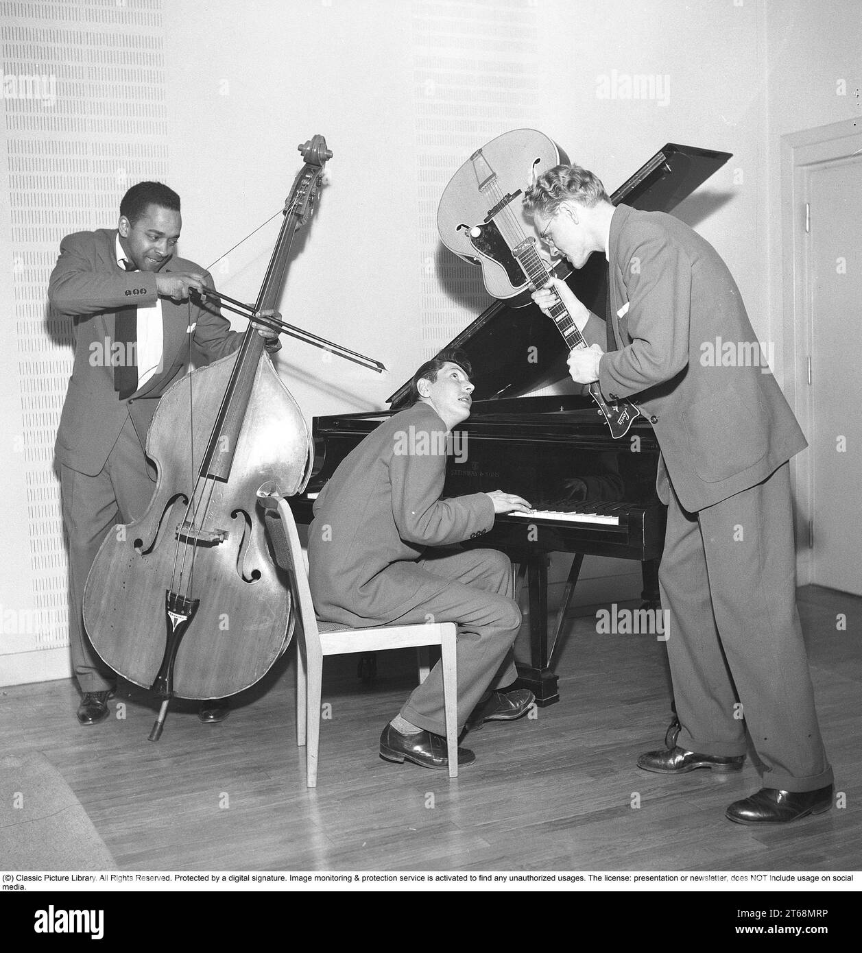 An unknown musical trio where the bassist and guitarist seem less than ...