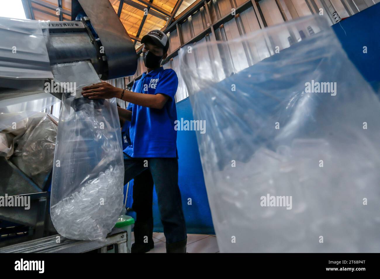 Workers pack crystal ice cubes at a crystal ice cube factory in Bogor ...