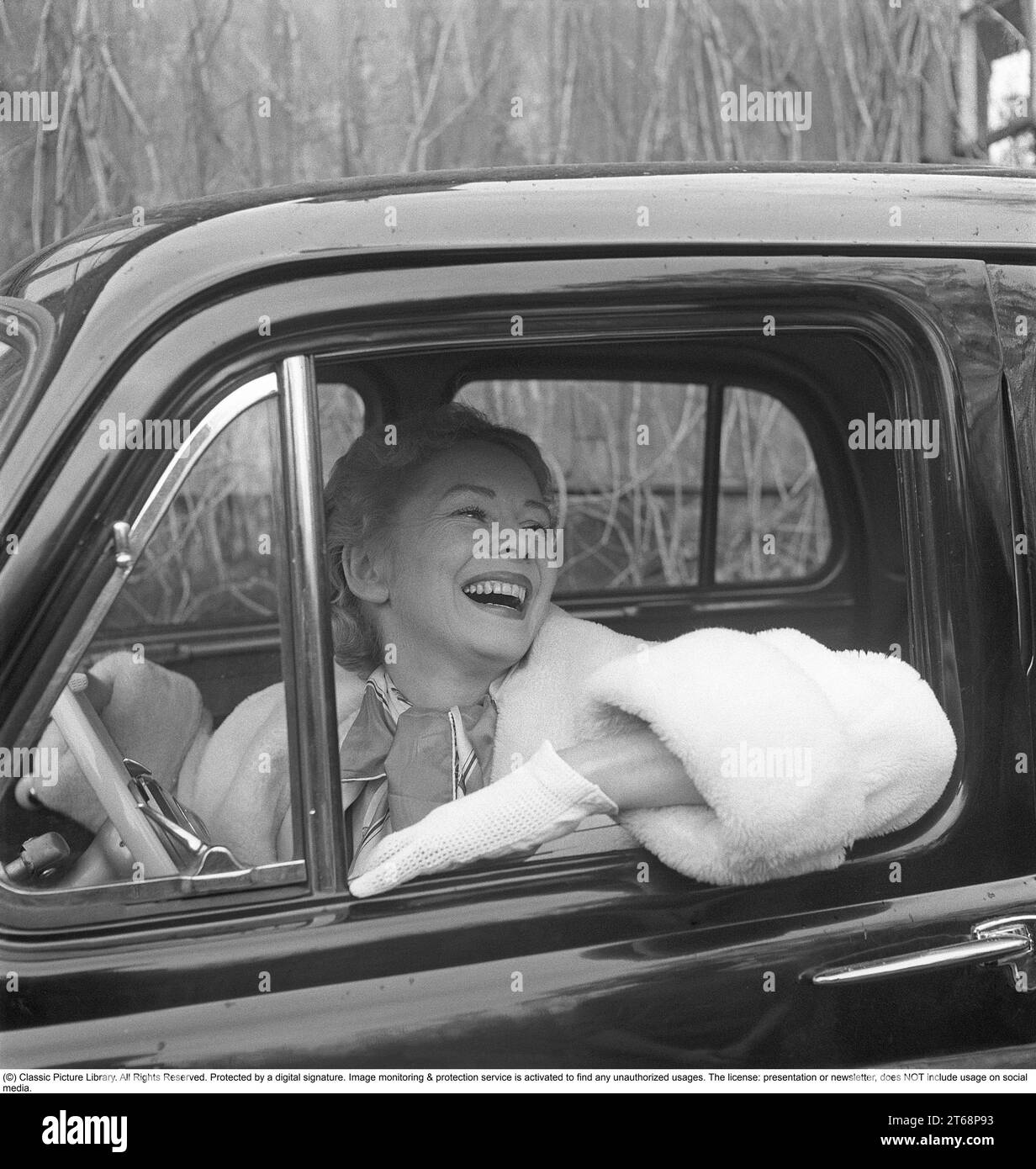 In the 1950s. Actress Sonja Wigert, 1913-1980 pictured in her car 1954 where she is seen smiling ...