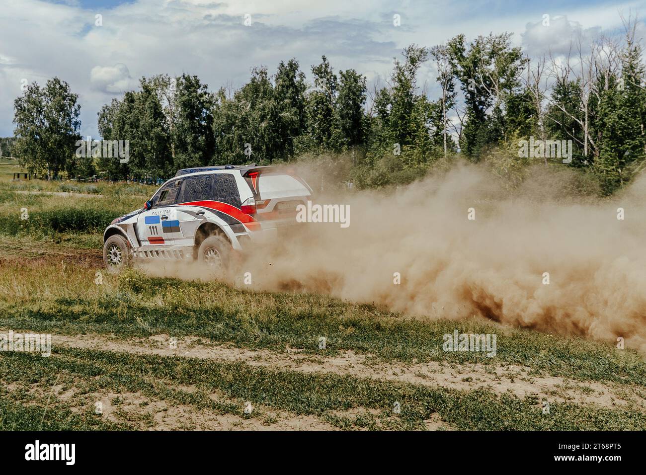 rear view racing car moving on terrain road in cross country rally ...