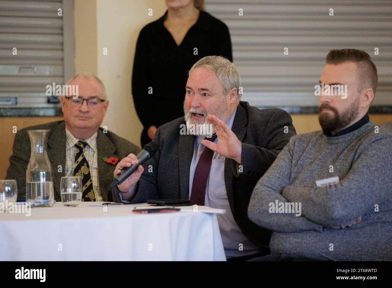 Sinn Fein MLA Colm Gildernew (centre) puts a question to Neil Gibson ...