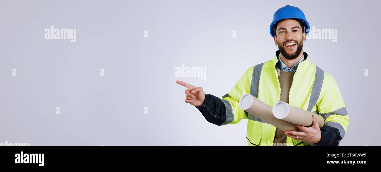Portrait, pointing and man engineer with blueprint in studio with ...