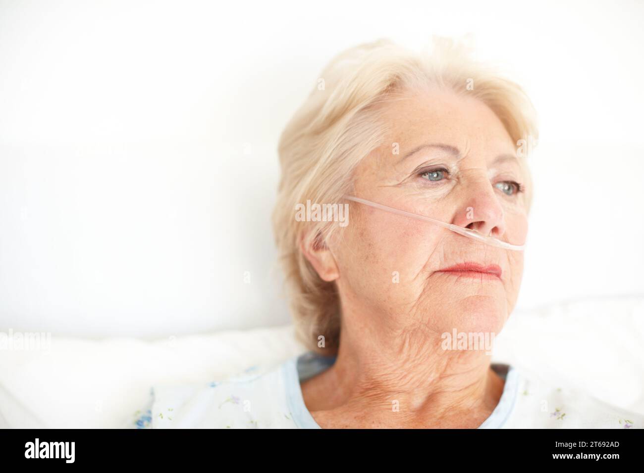 A heavy heart - Illness. Ailing senior woman wearing a nasal cannula ...