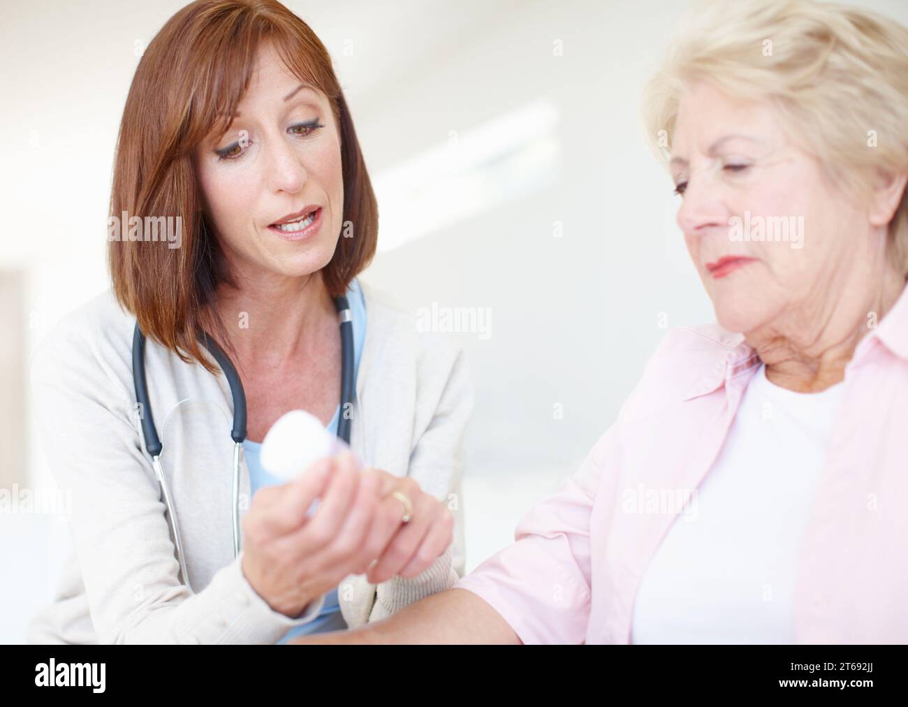 Explaining the dosage and effects - Senior Care. Mature nurse explains ...