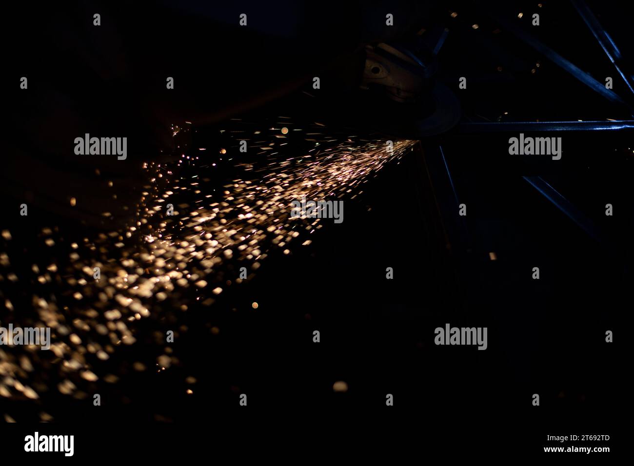 Sparks from grinding. Metal work. Steel profile cutting parts. Lights ...